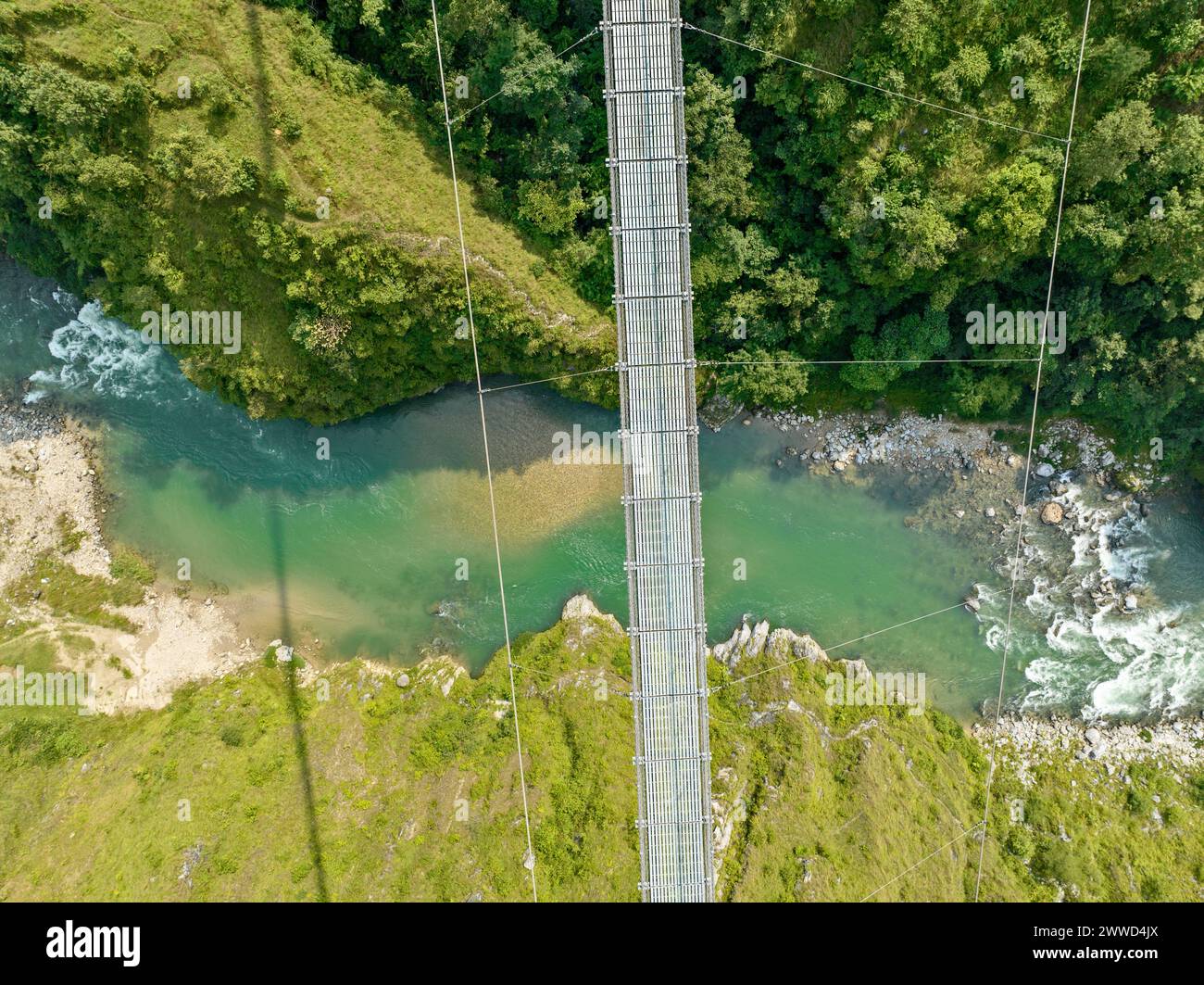 Aerial view of a Tibetan suspended bridge in Nepal is a primitive type ...