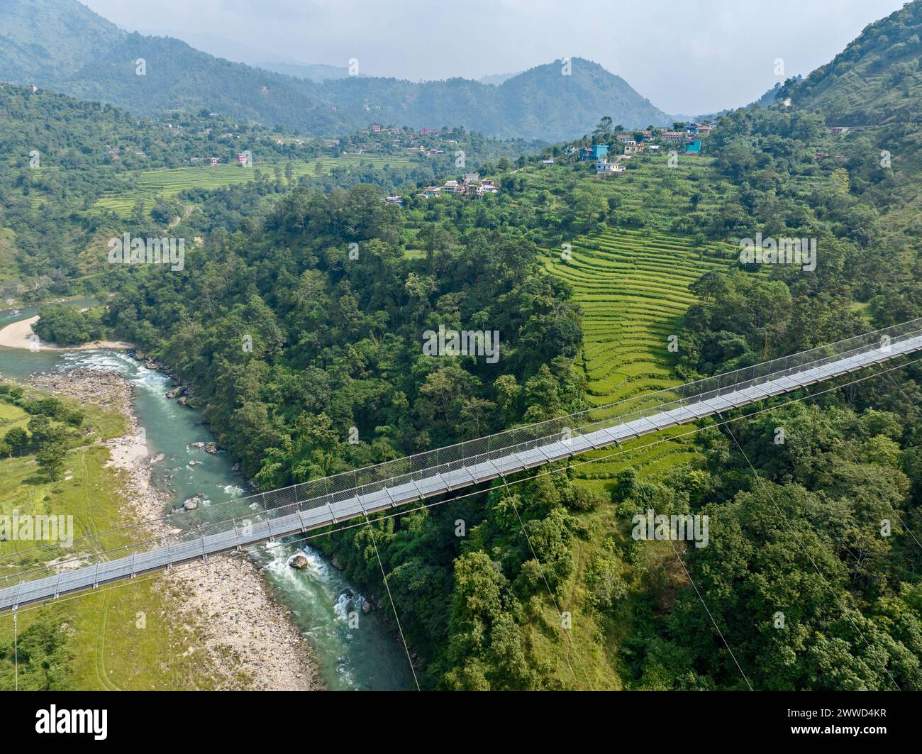 Aerial view of a Tibetan suspended bridge in Nepal is a primitive type ...