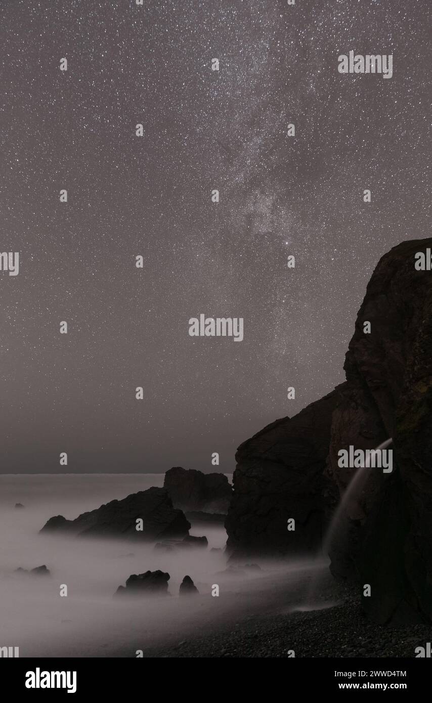 Waterfall onto a beach at midnight, Sandymouth, Cornwall Stock Photo ...