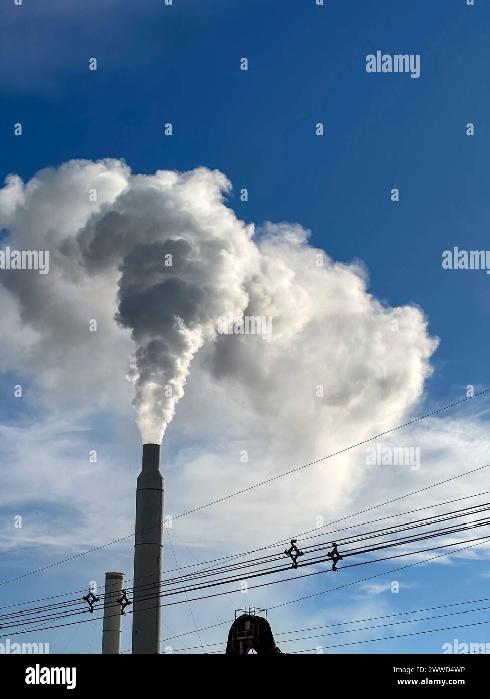 Factory chimney releasing smoke into the atmosphere Stock Photo - Alamy