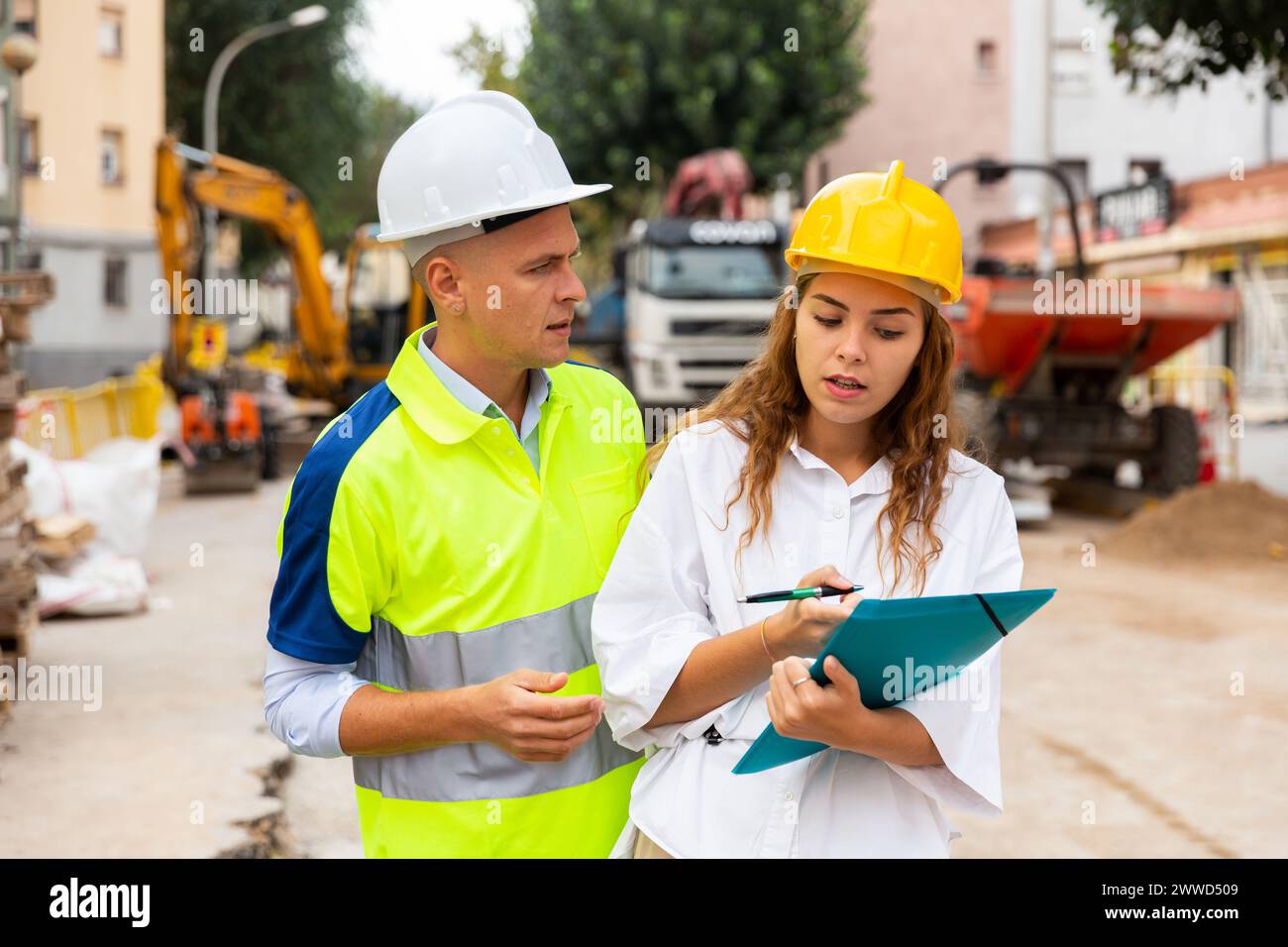 Civil engineers checking work process in construction site Stock Photo ...