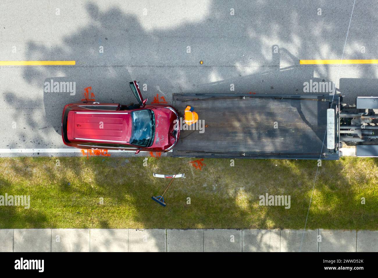 Traffic accident with tow truck hauling smashed vehicle on car crash ...