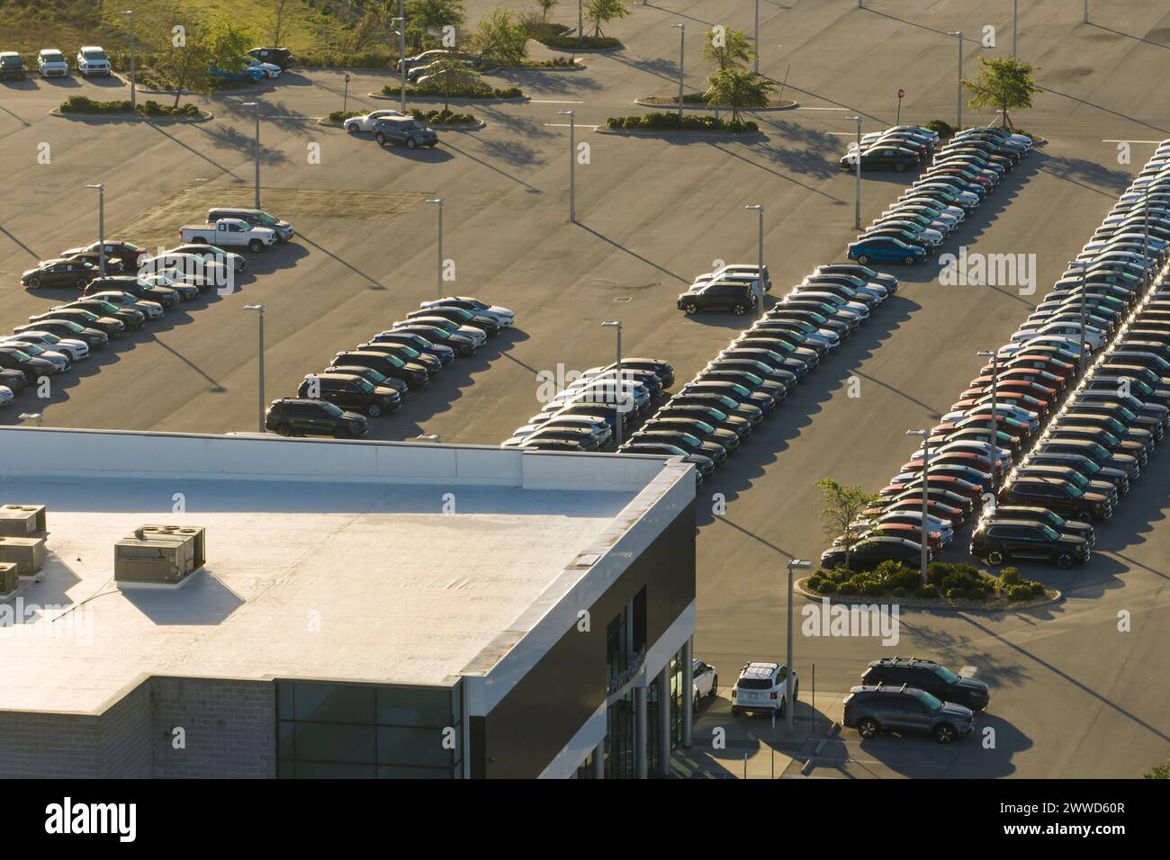 Aerial view of dealership parking lot with many brand new cars for sale ...