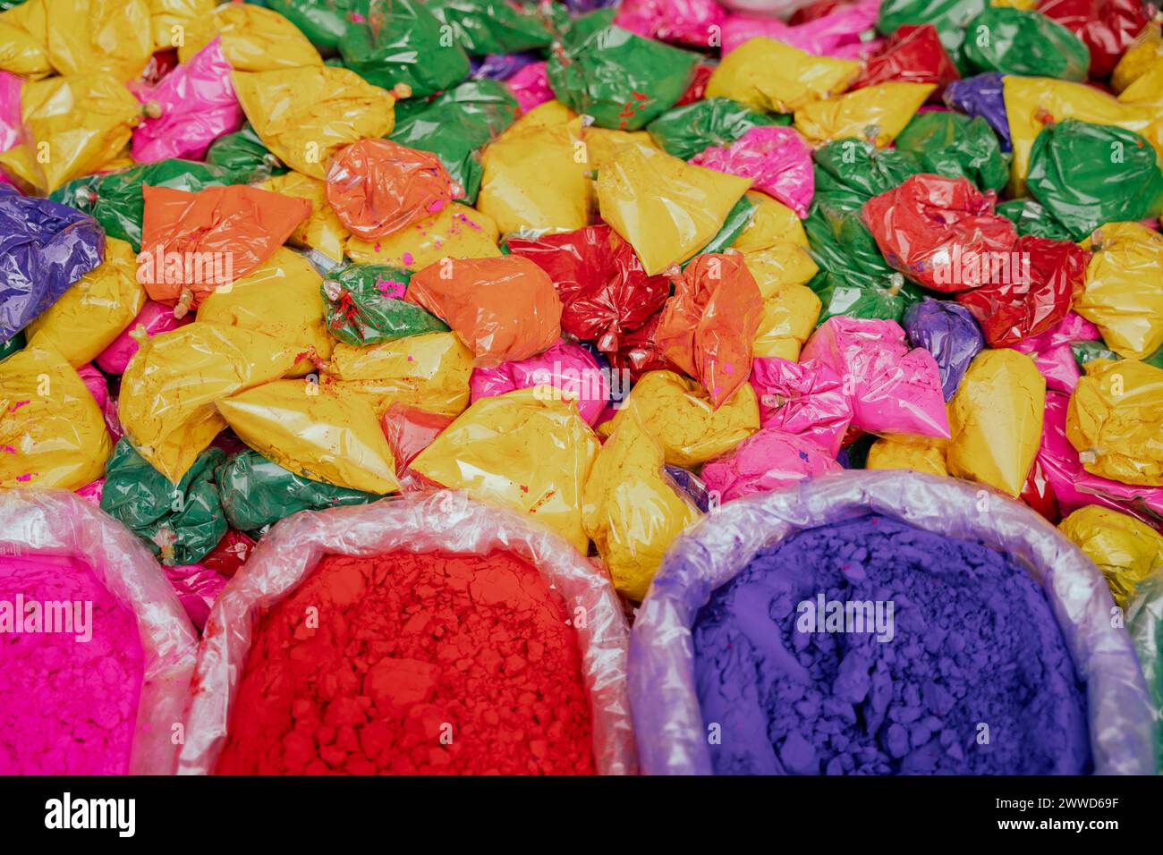 Vendor sells Holi celebration items in a street market, ahead of Holi ...