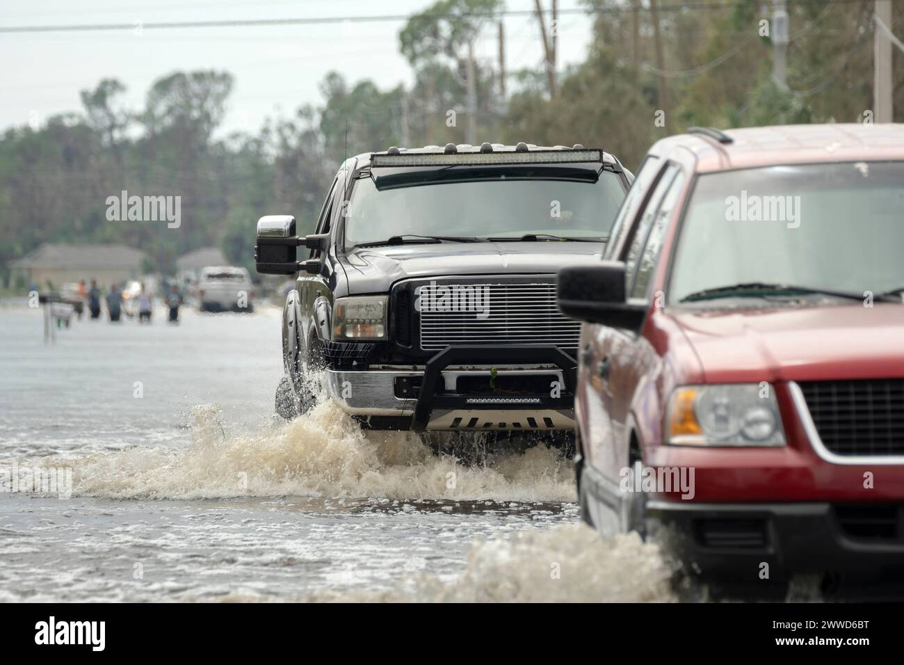 Flooded street after hurricane rainfall with driving cars in Florida ...