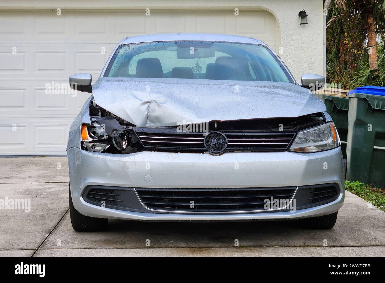 Dented car damaged after traffic accident parked on private home ...