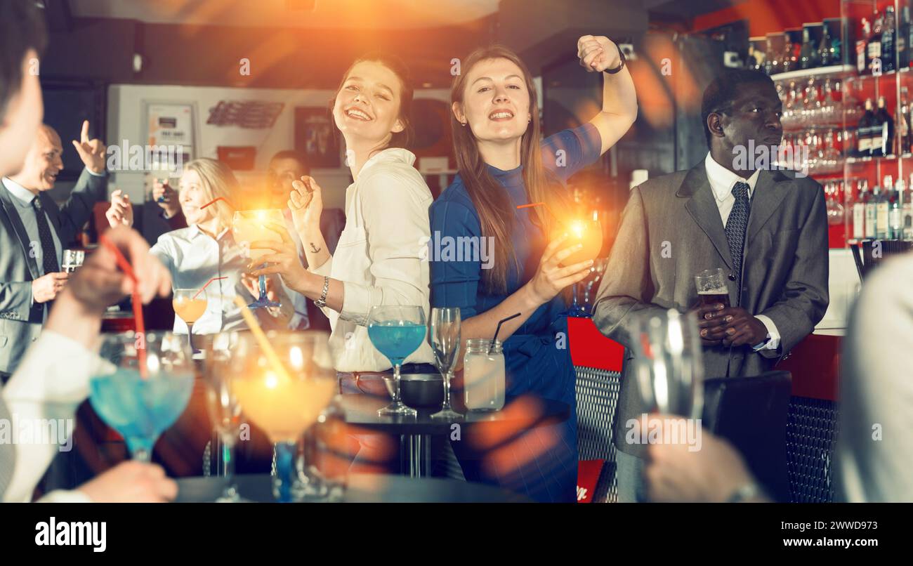 Two young women drinking cocktails Stock Photo - Alamy