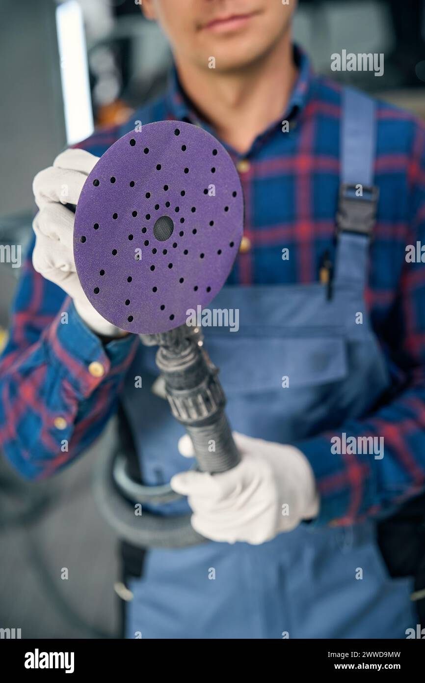 Worker working with instrument for polish surface Stock Photo - Alamy