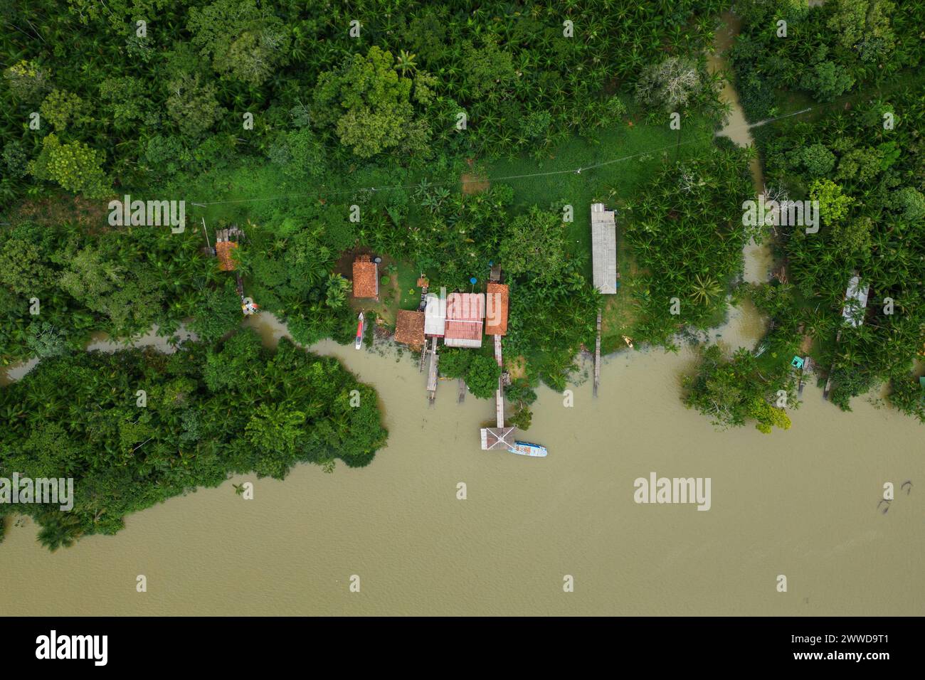 Aerial View of a Small Community Houses in Tropical Rainforest by the ...