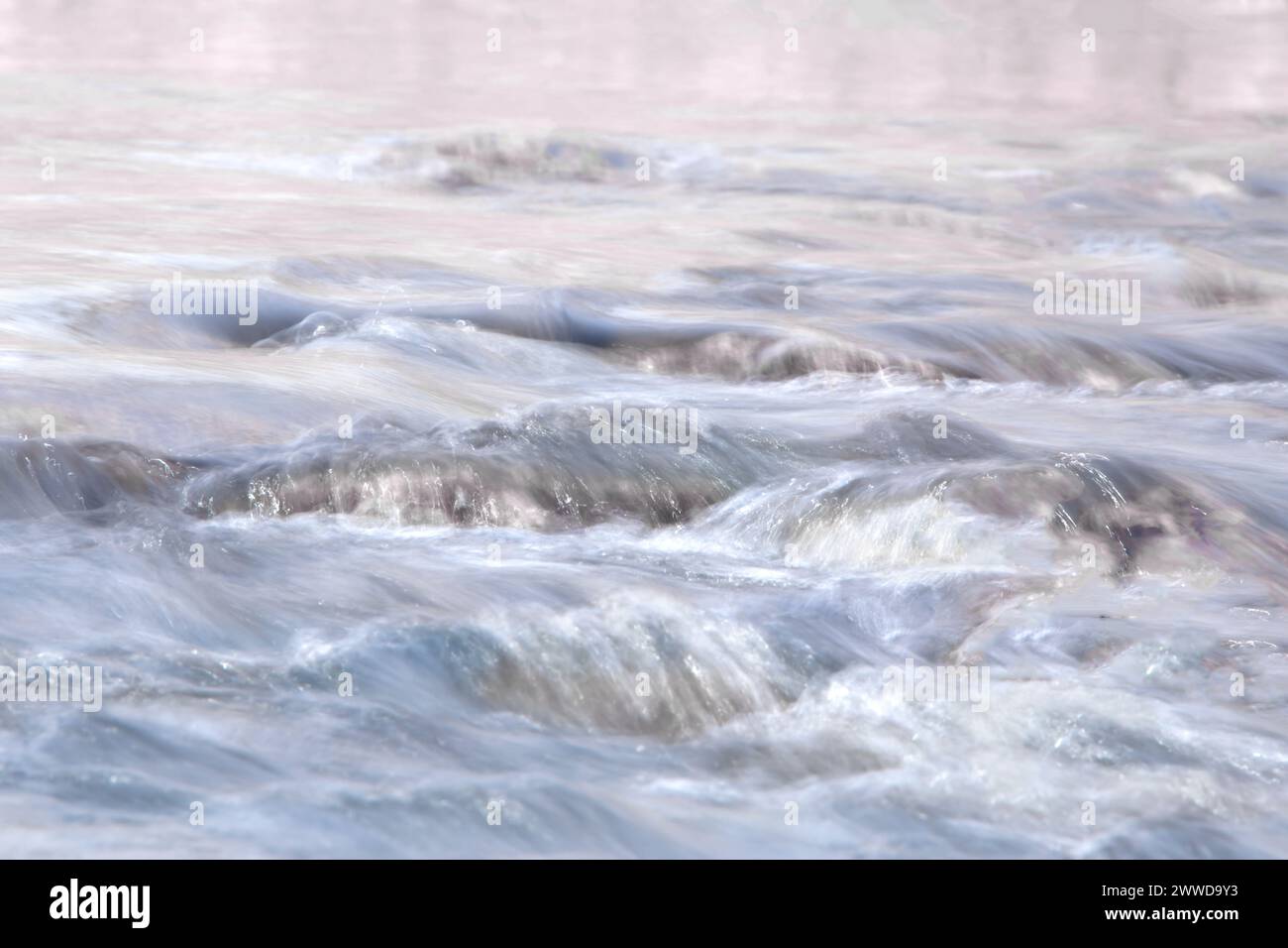 Bright water landscape of water flowing down a stream with soft pastel ...