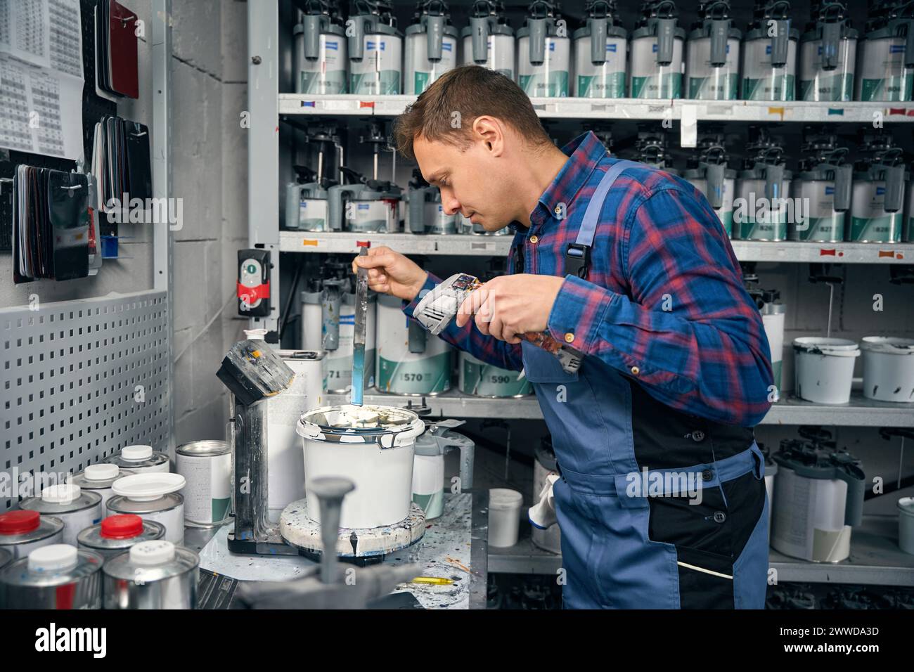 Mechanic selection and mixing of colors for car painting Stock Photo ...