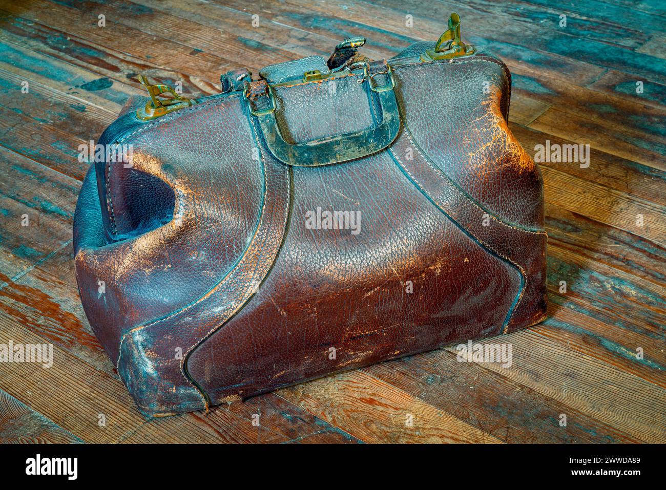 old vintage leather medicine bag on a dusty wooden floor Stock Photo ...