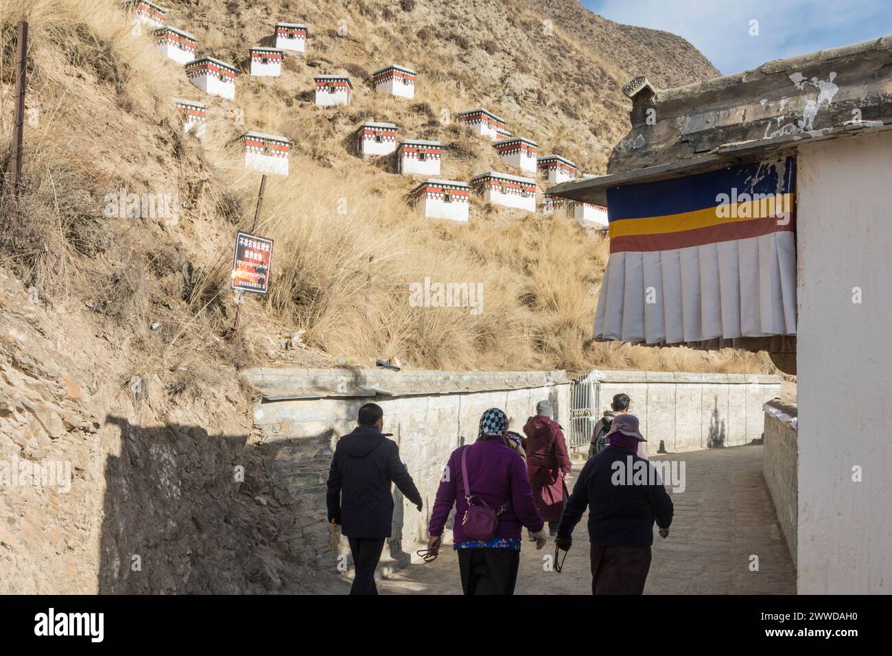Pilgrims passing small meditation huts while doing circumambulation ...