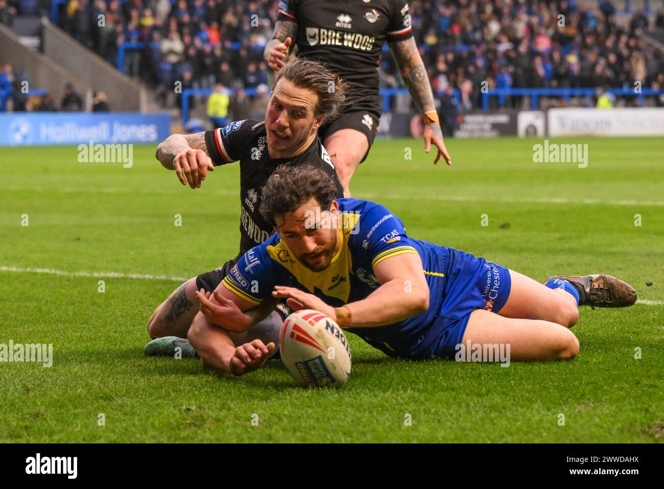 Toby King of Warrington Wolves goes over for a try during the Betfred ...