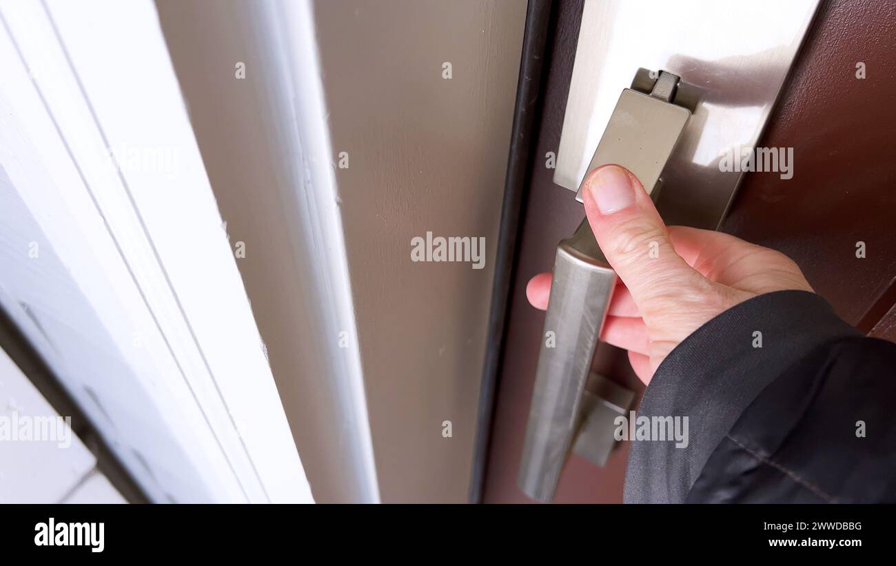 Hand Opening a Modern Door with Metal Handle Stock Photo - Alamy