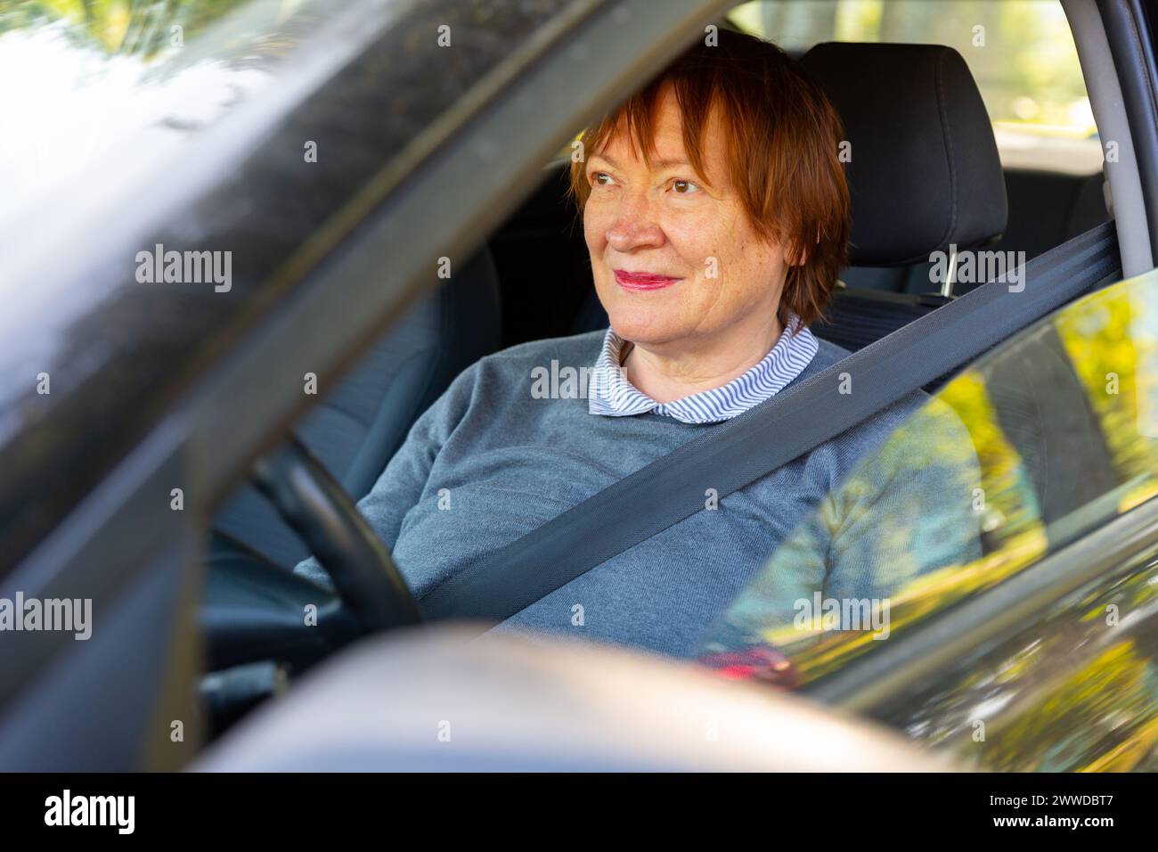 Positive mature woman sitting inside her car Stock Photo - Alamy Positive mature woman sitting inside her car Stock Photo - Alamy