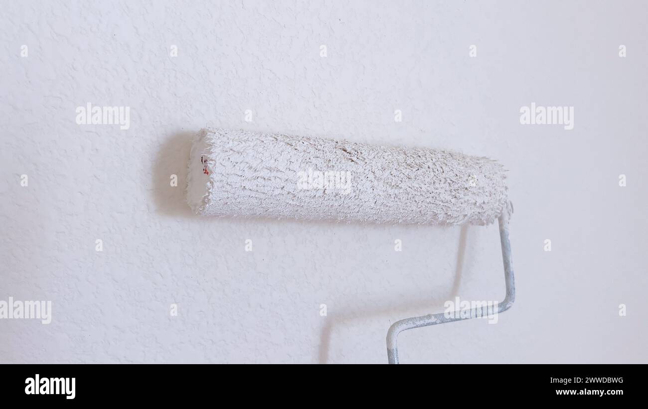 Painting a Wall with White Paint Roller Stock Photo - Alamy