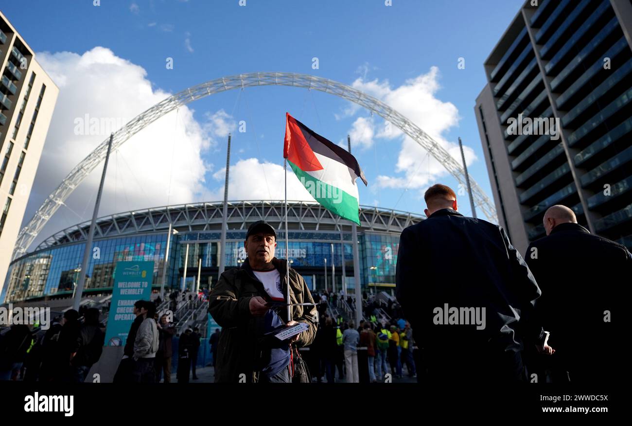 People holding flags in support of Palestine outside the stadium on ...