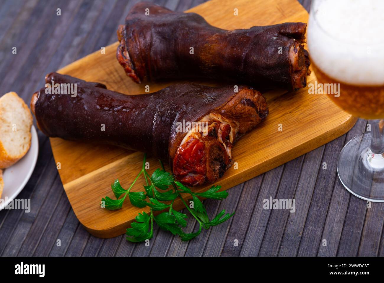 Picioare de porc afumate - juicy smoked pig legs on wooden board ...