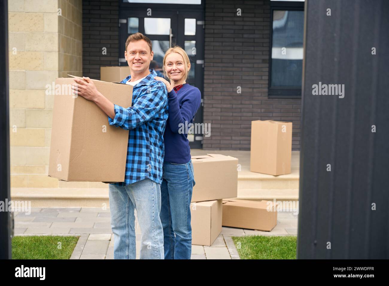 Cheerful man handling box hi-res stock photography and images - Alamy
