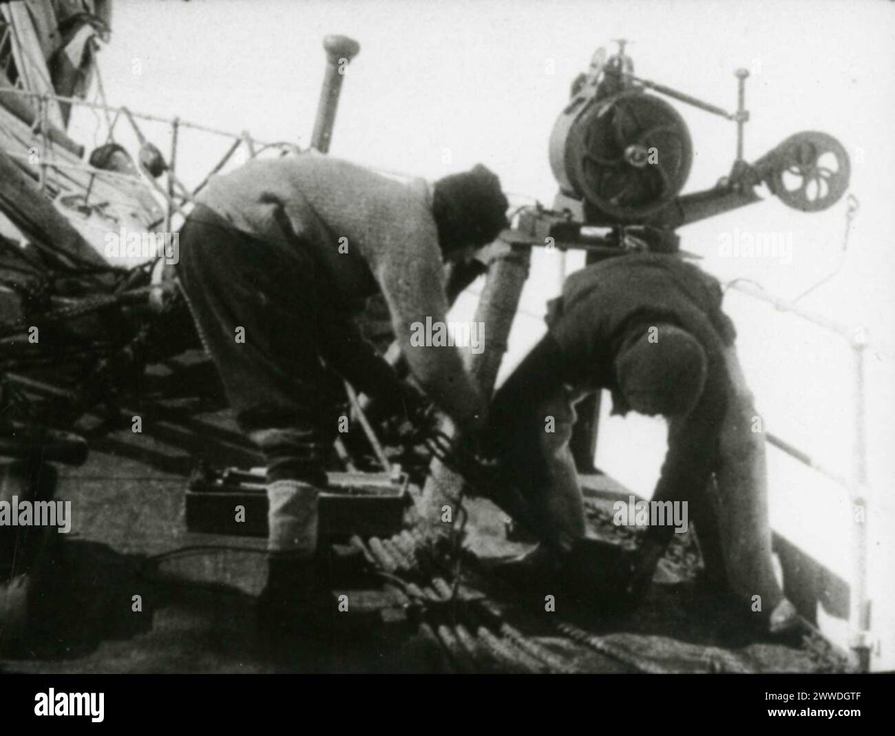 Two men handling sounding instrument Description: 'Photograph ...