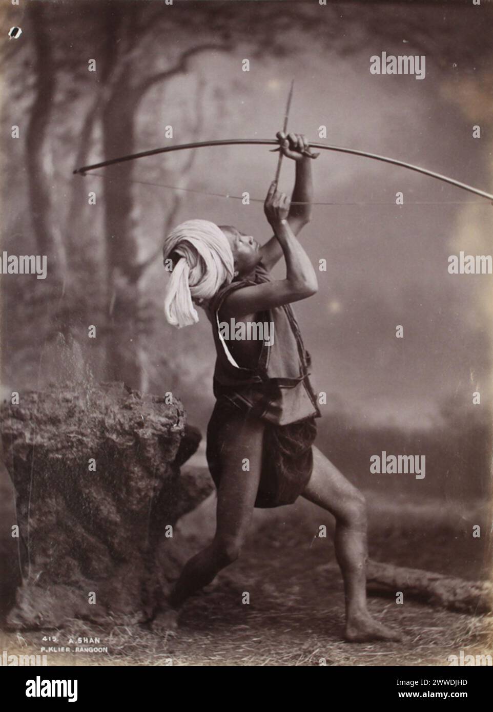 A 1907 photograph by Philip Klier showing a Shan man with a bow and ...