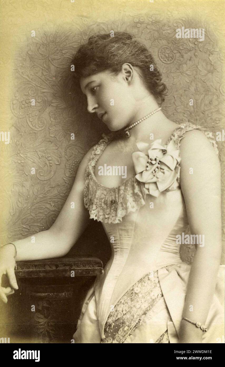 Portrait of actress and socialite Lillie Langtry standing, wearing a ...