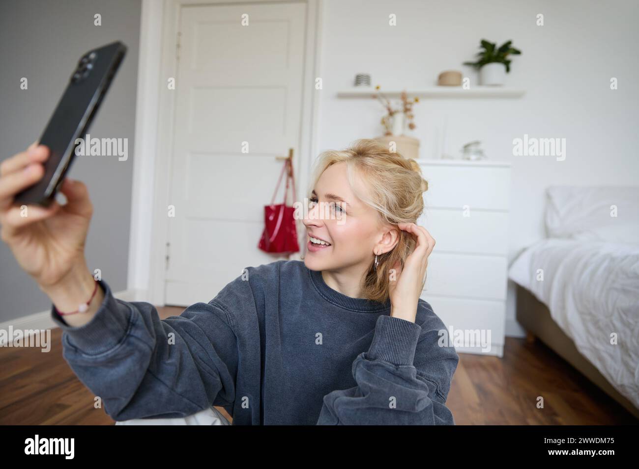 Portrait of young woman, social media influencer, taking selfies in her ...