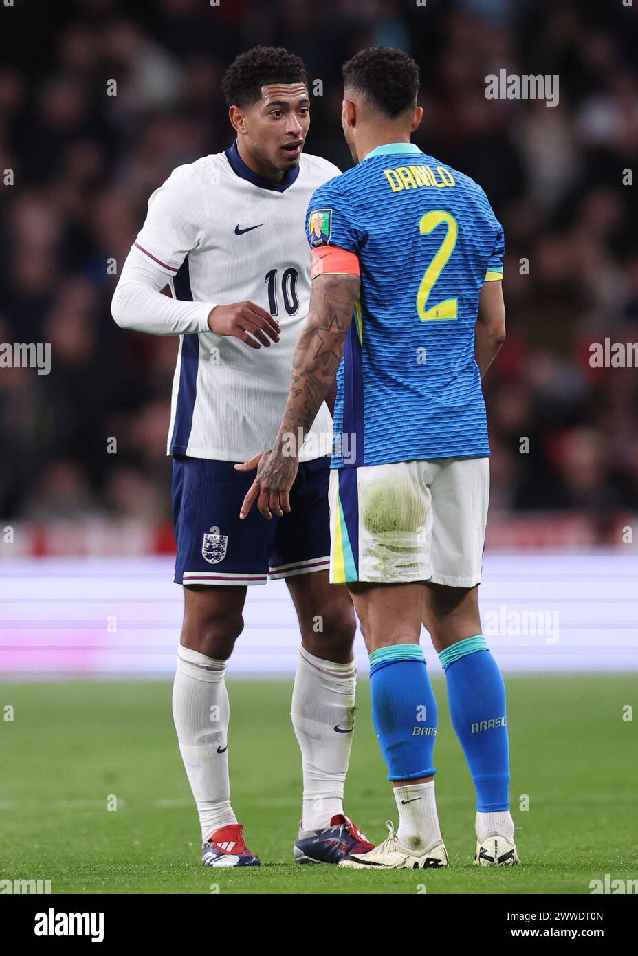 London, UK. 23rd Mar, 2024. Jude Bellingham of England engages with Danilo Da Silva of Brazil ...