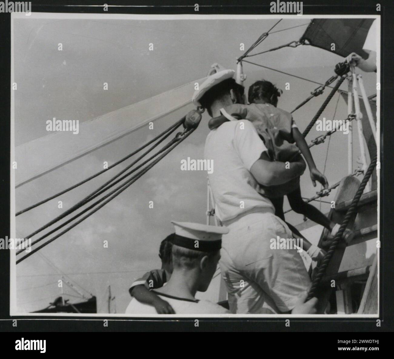Description: Some of the orphans being assisted on board by members of ...