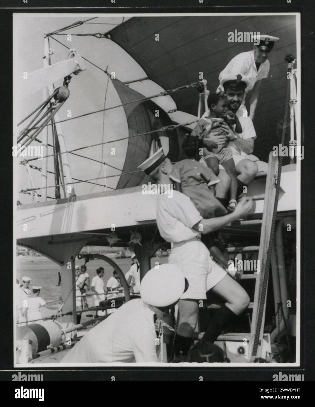 Description: Some of the orphans being assisted on board by members of ...