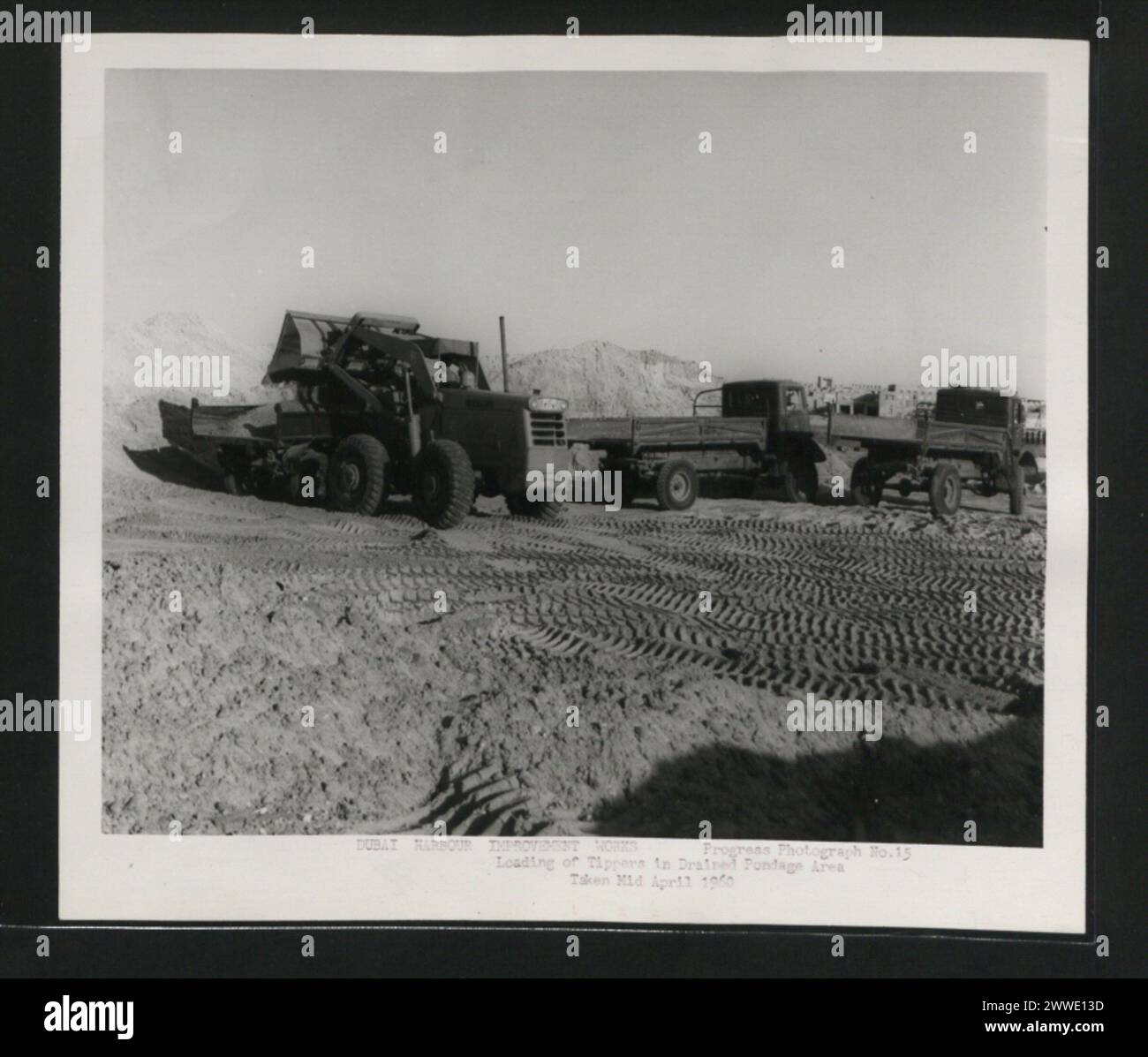 In April 1960, Dubai Harbour improvement works show tippers being ...