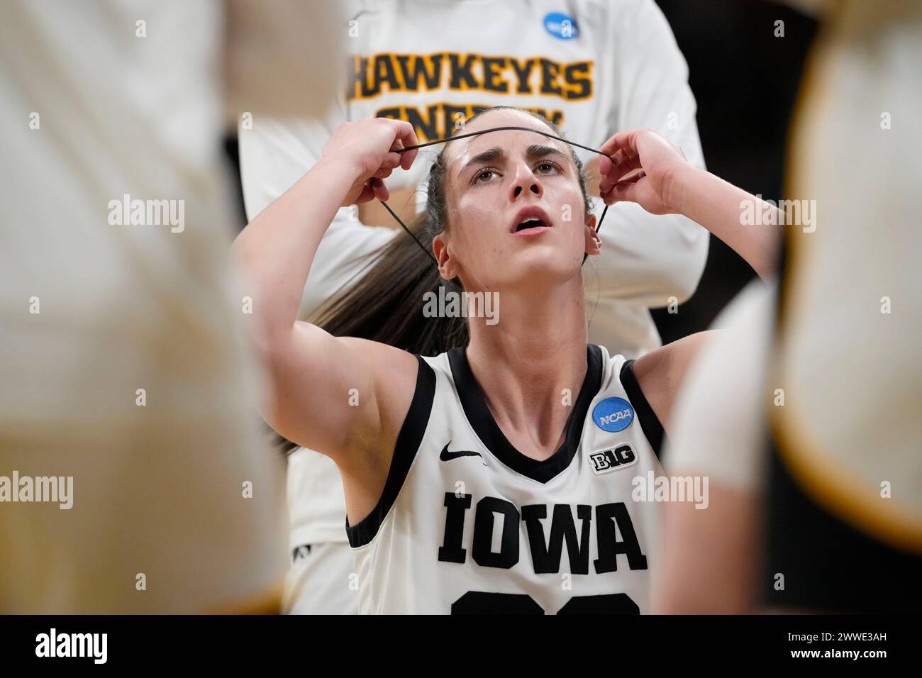 Iowa guard Caitlin Clark (22) adjusts a headband during a timeout in ...