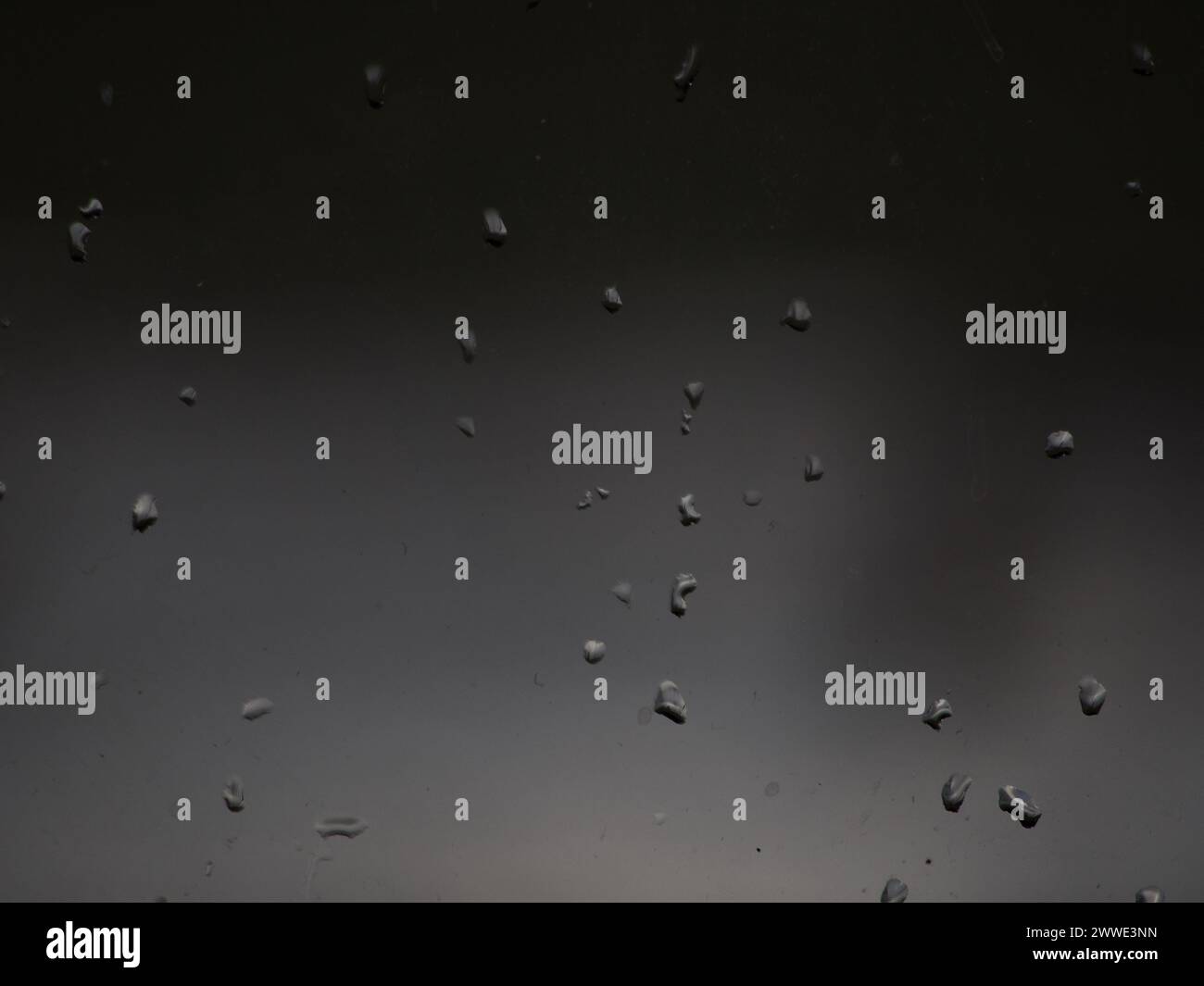 Rain drops on a window with out of focus background Stock Photo - Alamy