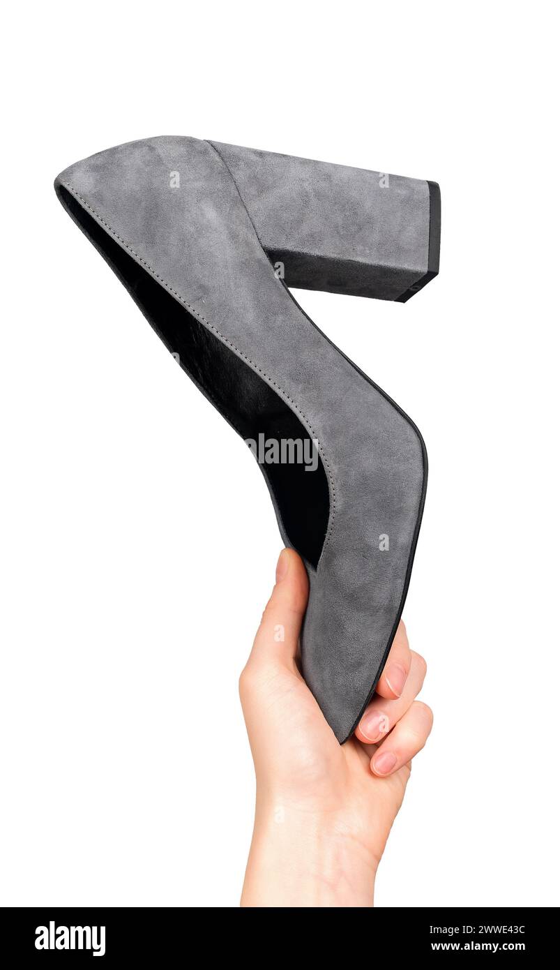 Hand holding suede shoe with, gray heeled footwear, isolated on white ...