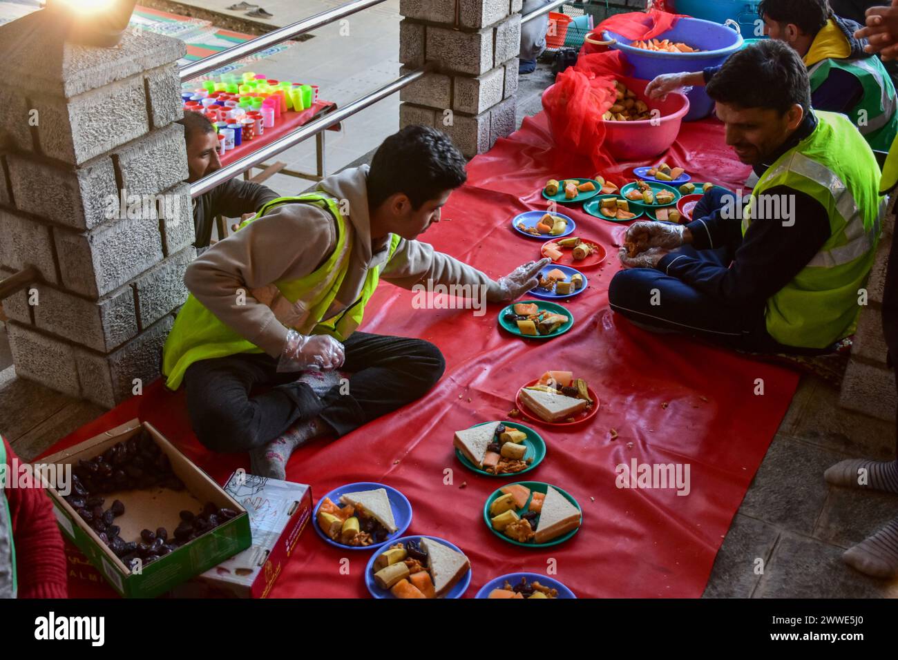 Volunteers prepare Iftar, the evening meal to break fast, at the Masjid ...
