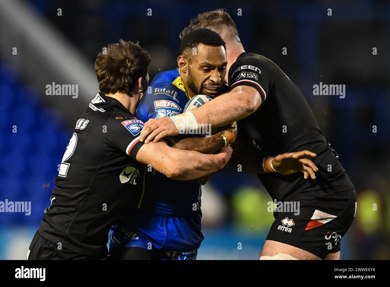 Rodrick Tai of Warrington Wolves is tackled by Lee Kershaw of London ...
