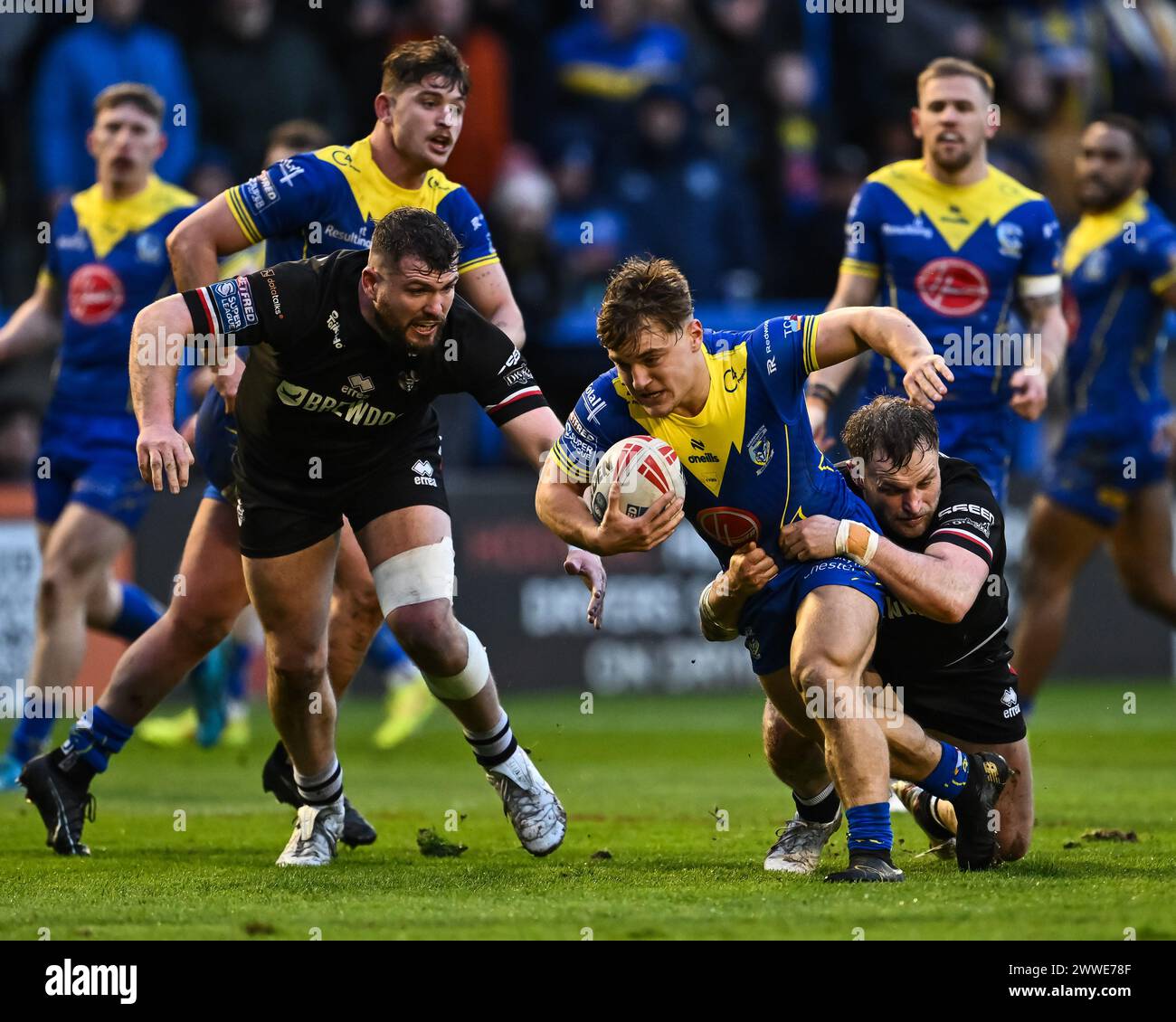 Leon Hayes of Warrington Wolves is tackled by James Meadows of London ...