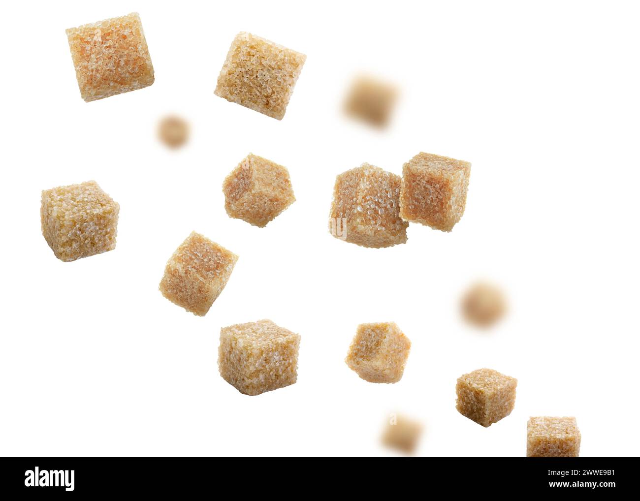 Brown cane sugar cubes falling on white background Stock Photo - Alamy