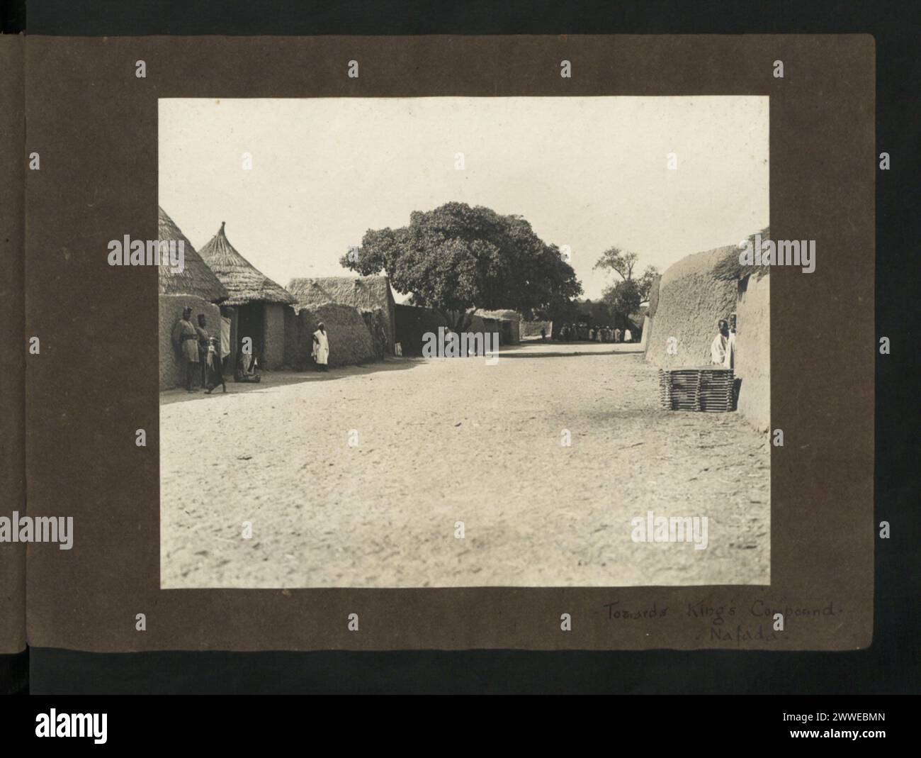 Description: Towards King's Compound, Nafada. A street scene with huts ...