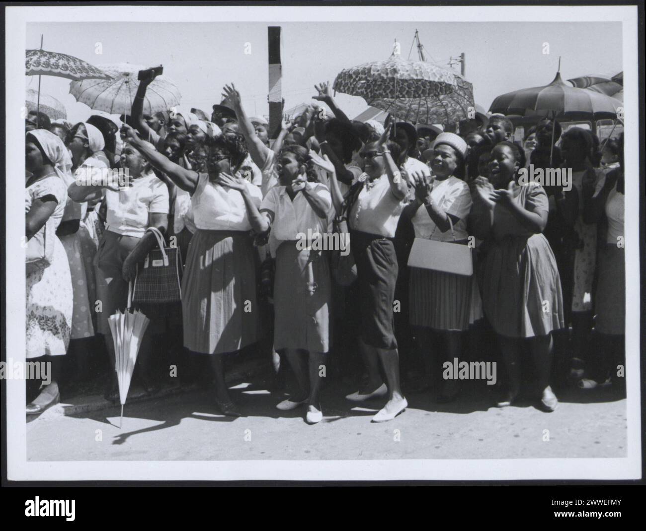 Photograph depicts women cheering and waving during the opening of ...