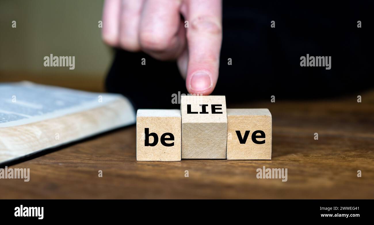Wooden cubes form the words believe and lie. Symbol for criticizing ...