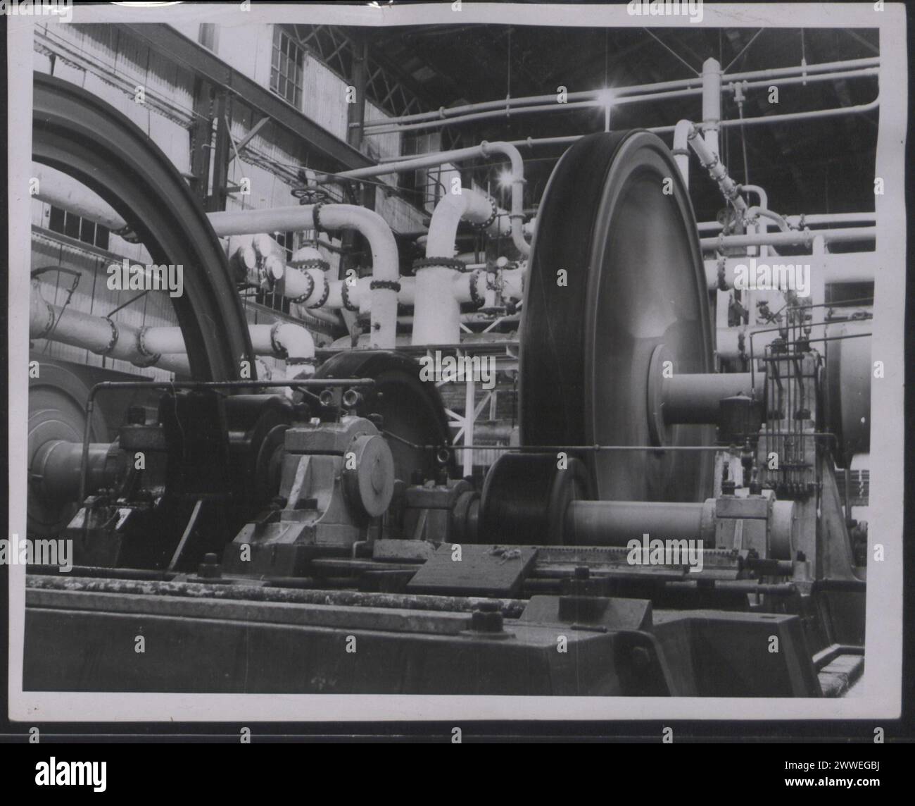 Heavy rollers crush sugar cane on West Indies plantations; the juice ...