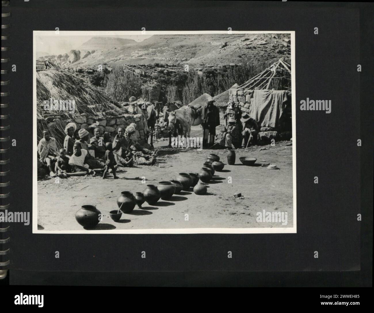 Photograph depicts a native market, showing local trade, goods, vendors ...