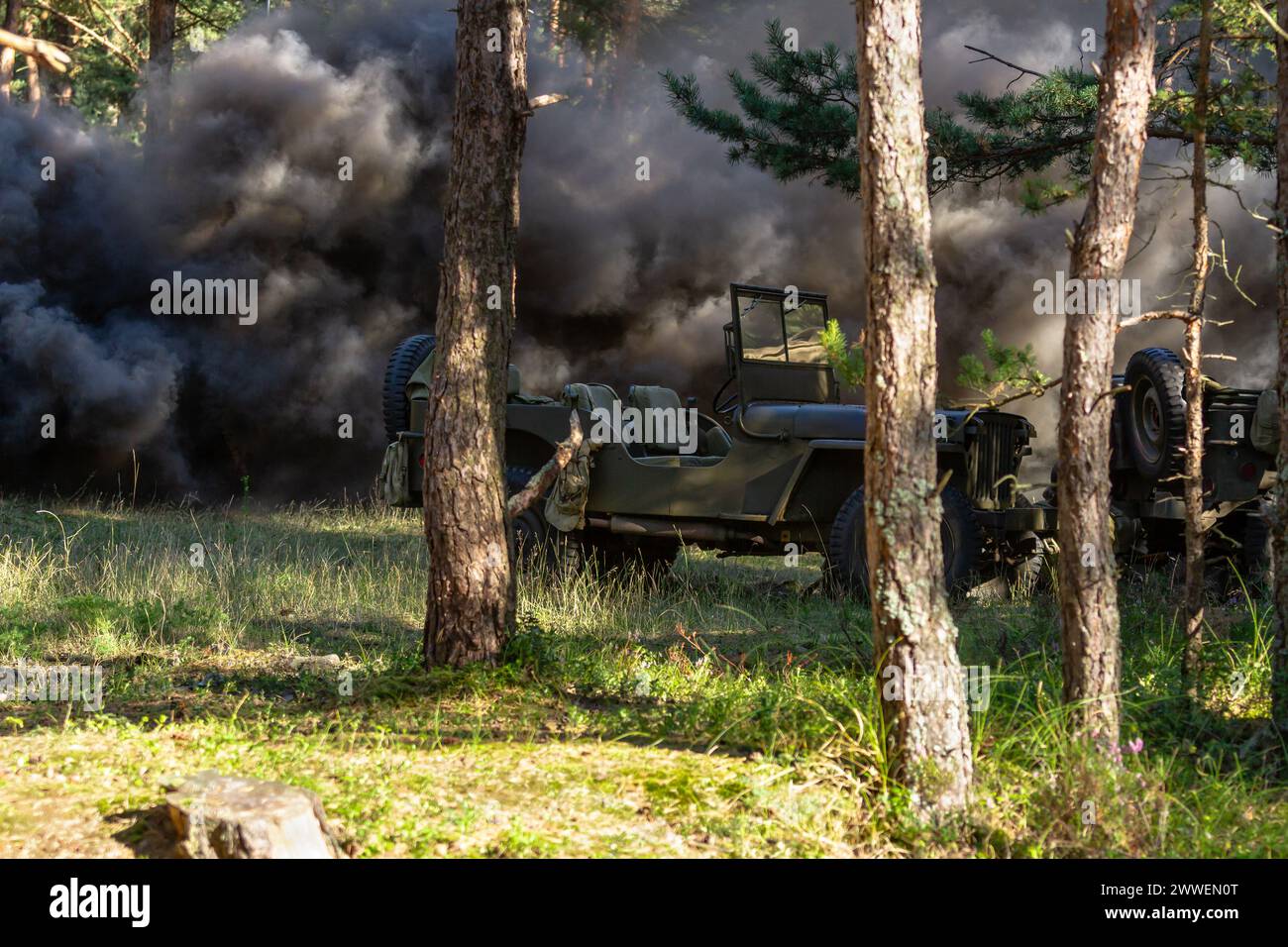 Historical reenactment. Two abandoned US military vehicles stand in the ...