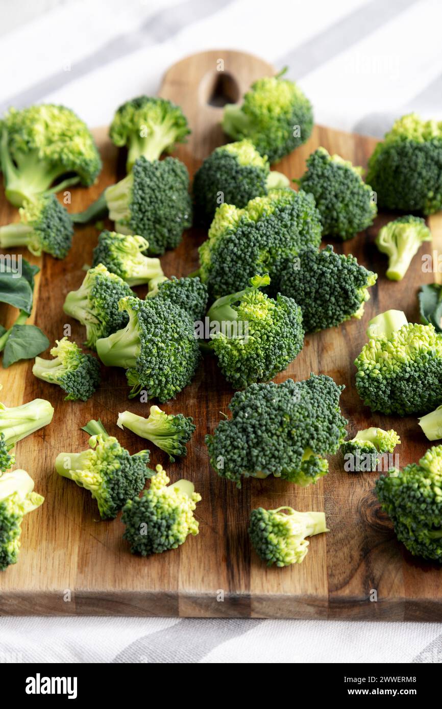 Organic Raw Broccoli Florets on a Wooden Board, side view Stock Photo ...