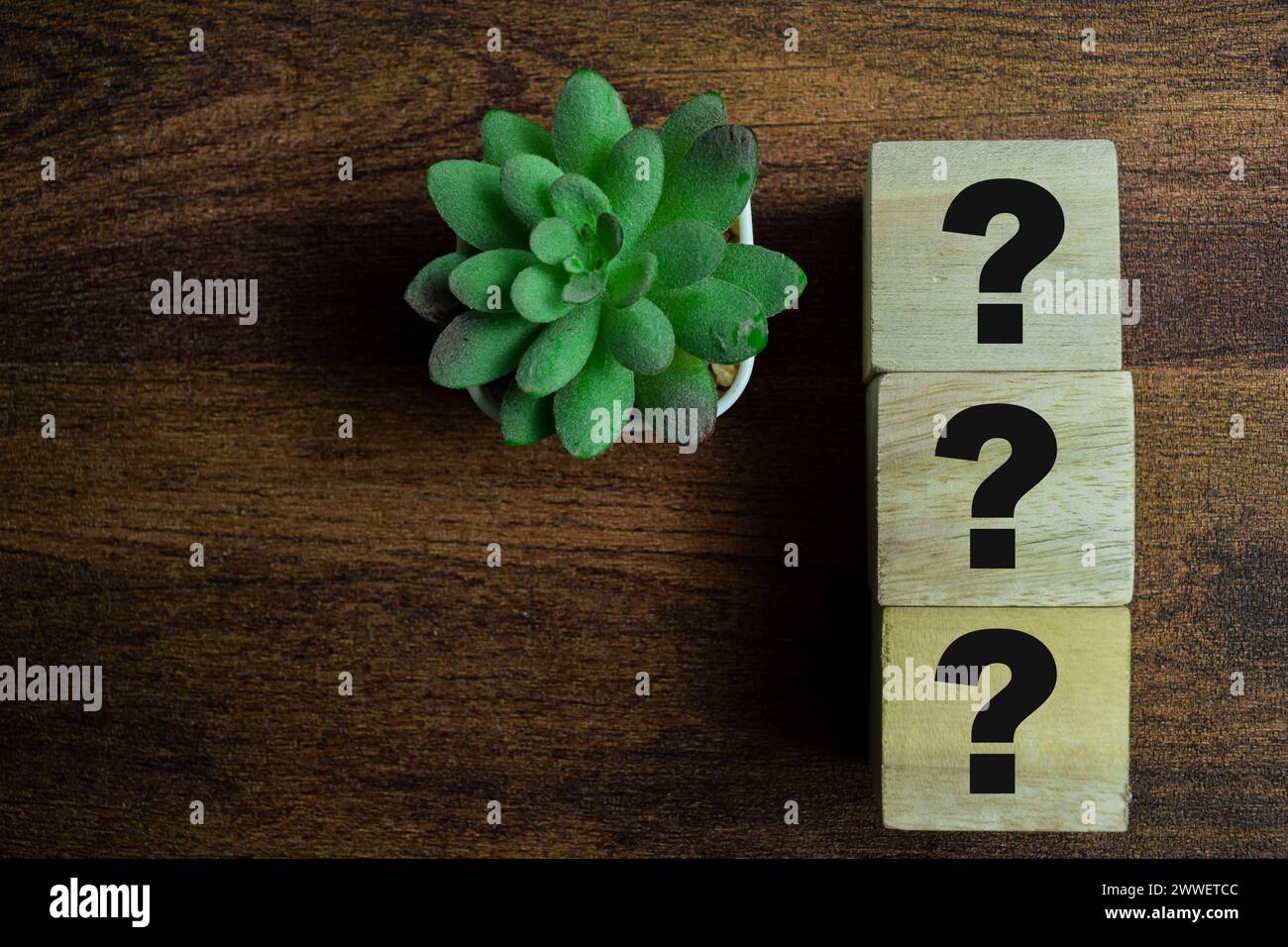 Concept of The wooden Cubes with the word Three question marks on ...