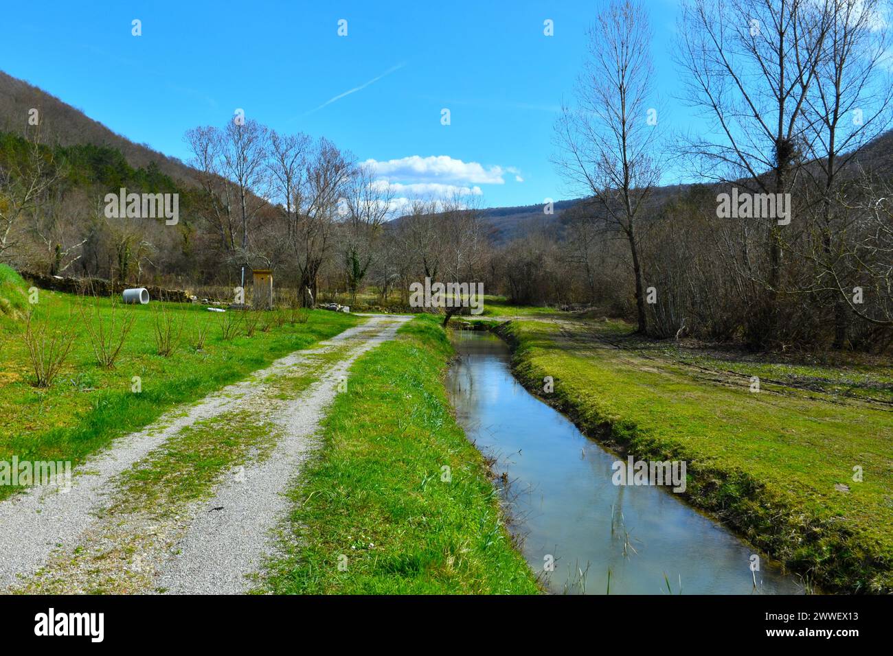 Gravel road next to a water channel in Dragonja valley in Istria ...