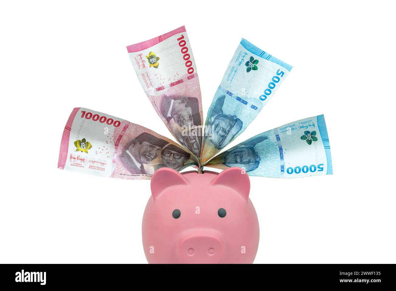 Indonesian currency. Piggy Bank stuffed with IDR 100,000 and IDR 50.000 ...