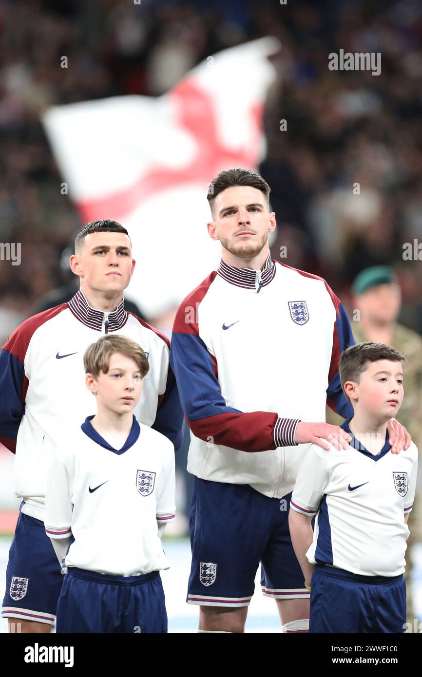 London, UK. 23rd Mar, 2024. Phil Foden and Declan Rice of England line ...
